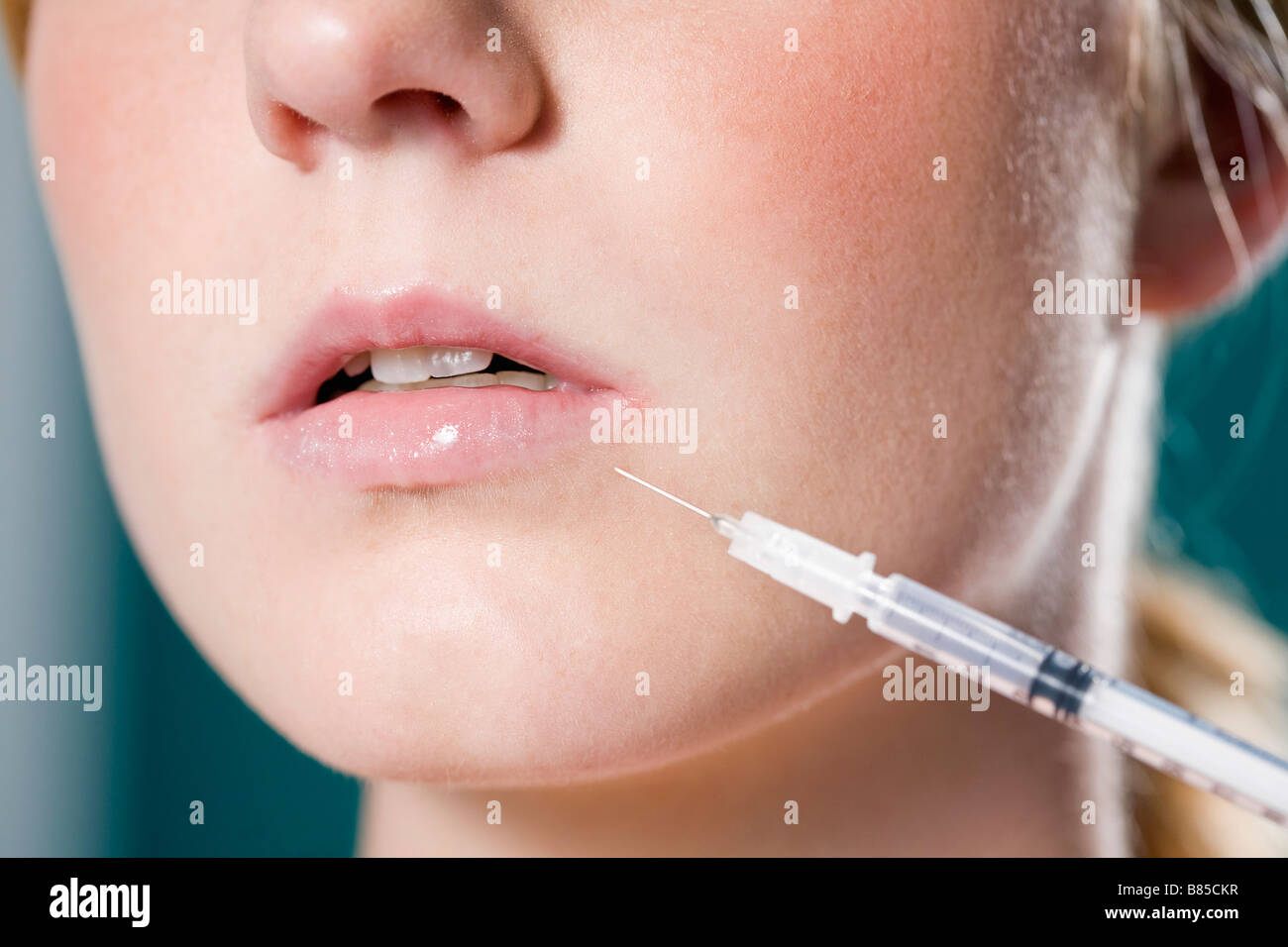 close-up of young woman getting injection in mouth Stock Photo - Alamy