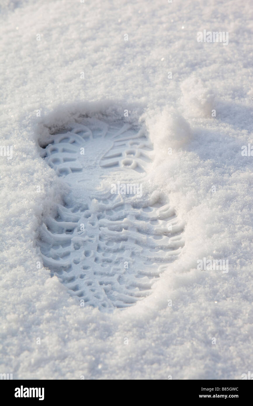 A footprint in snow Stock Photo - Alamy