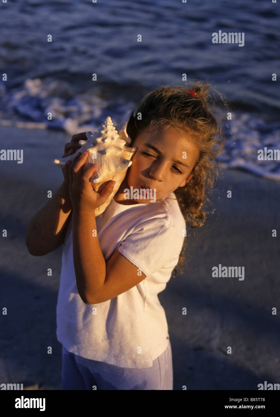 Girl with a seashell Stock Photo - Alamy