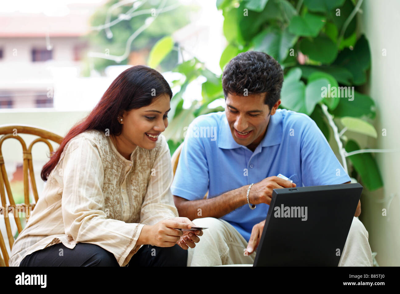 A couple using laptop Stock Photo - Alamy