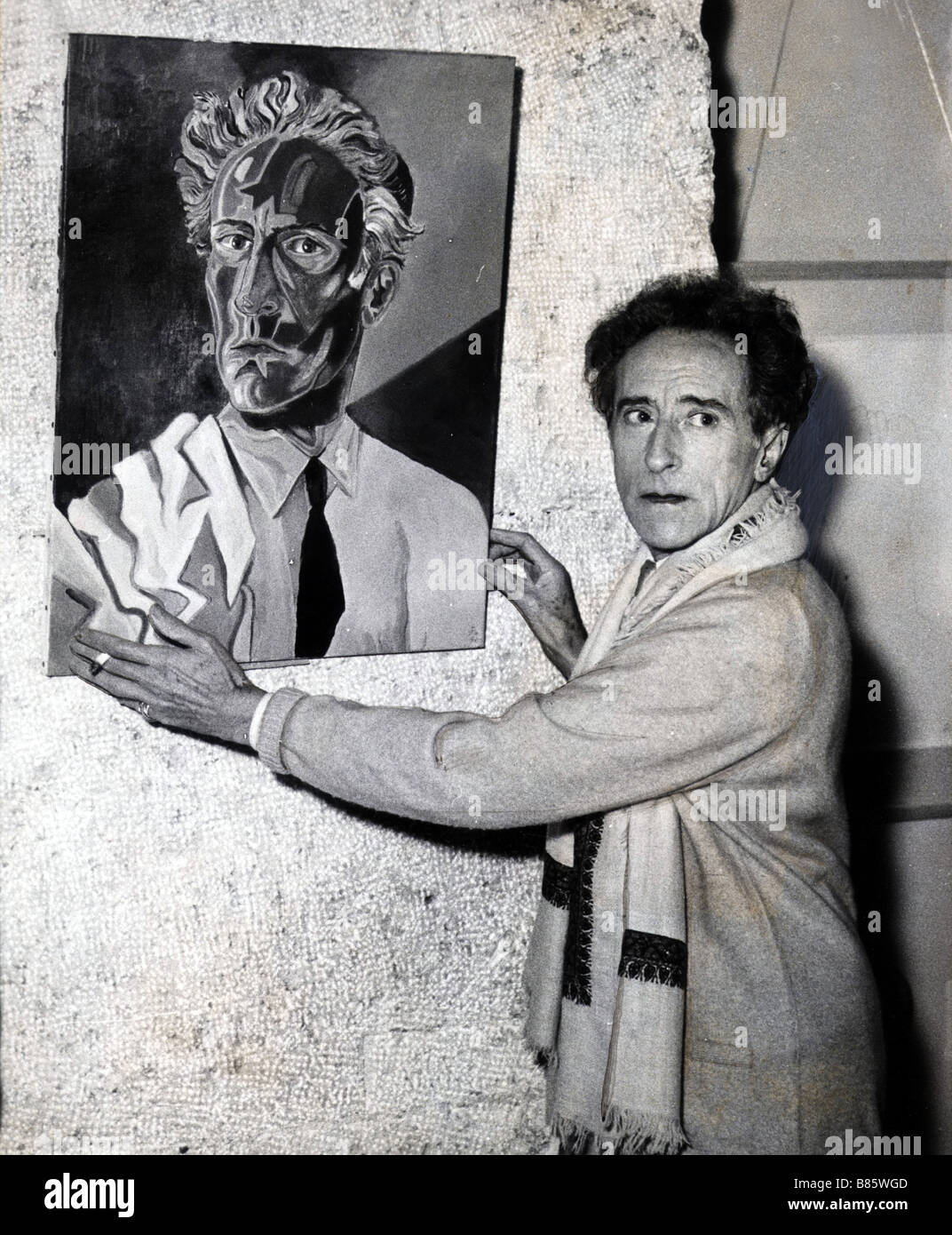Cocteau hanging his painting for an exhibition in Nice, 1953 Stock ...