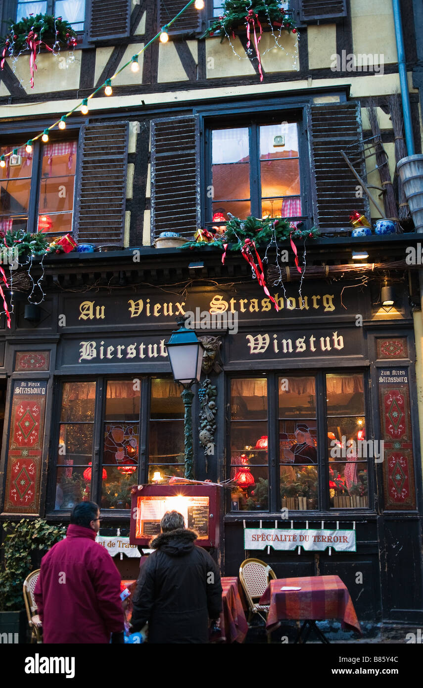 Couple looking at menu list of a wine and beer bar, Christmas time ...