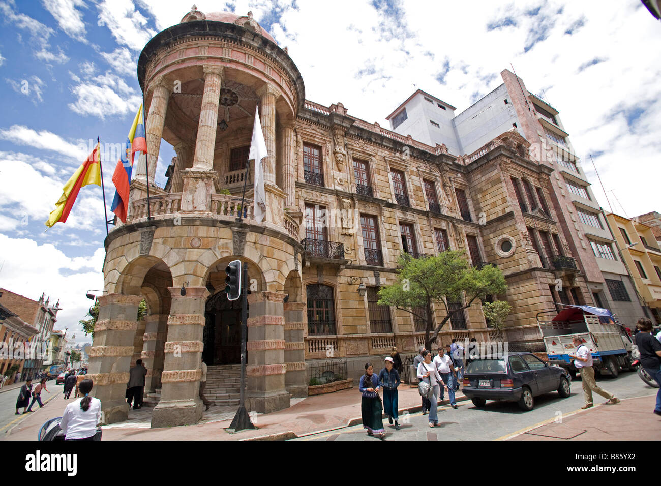 Official stone building with flags Street scene Cuenca Ecuador South ...