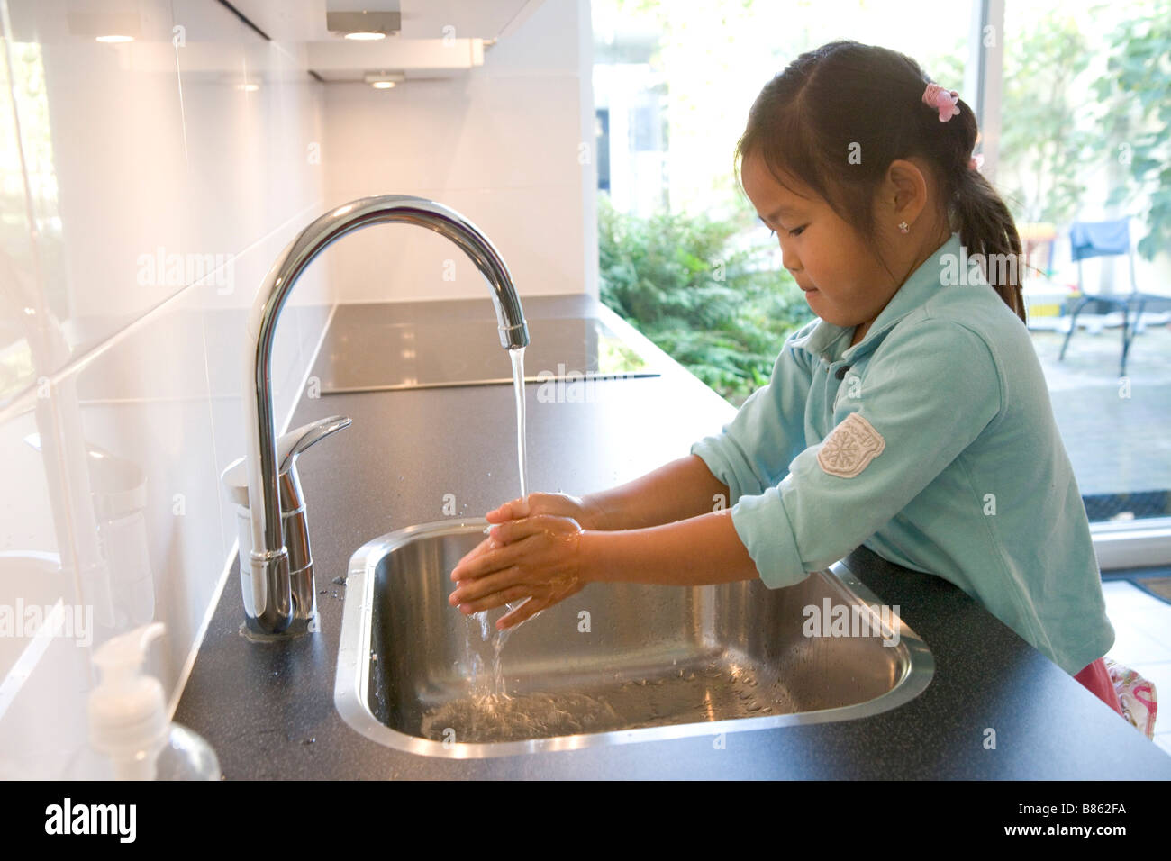 Little girl is washing her hands Stock Photo - Alamy