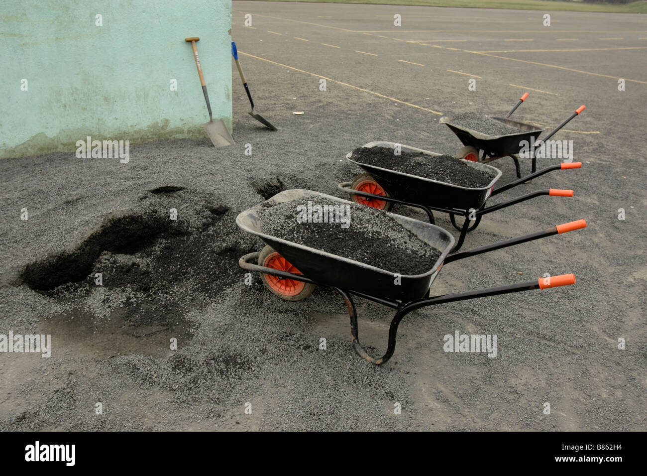Wheelbarrows carrying construction material Stock Photo - Alamy