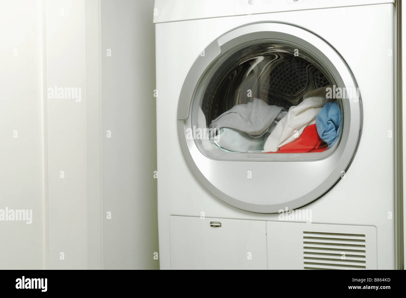Clothing inside a laundry washing machine drying machine Stock Photo ...