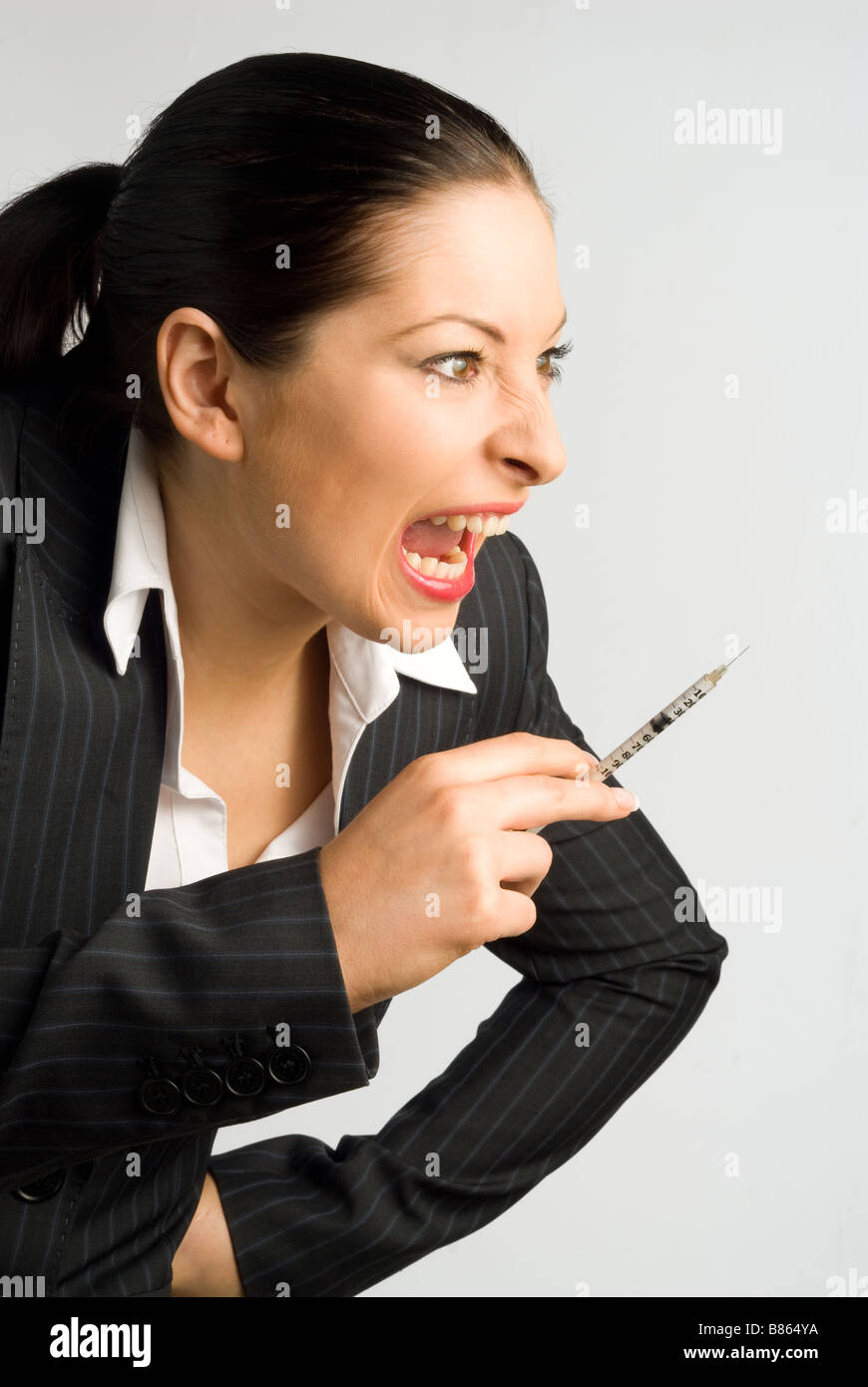 angry business woman with botox needle Stock Photo - Alamy