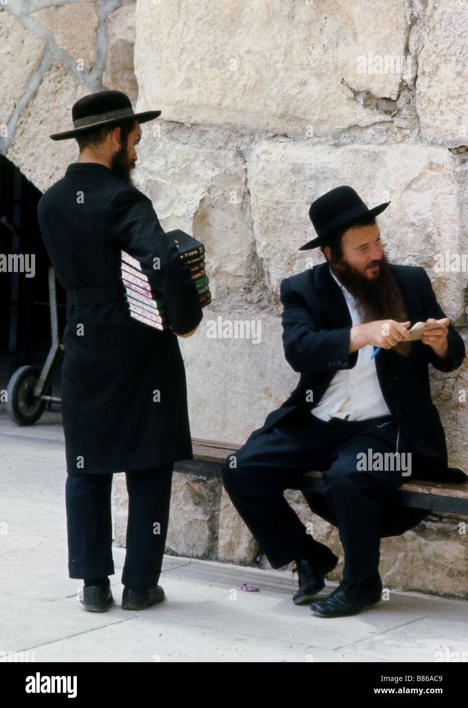 Orthodox jewish men seated in front of the western wall hi-res stock ...