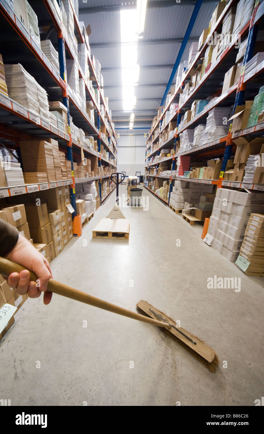 Sweeping the warehouse Stock Photo - Alamy