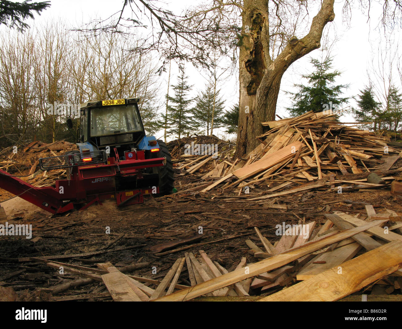 Tractor in woodyard, near Broadway Worcestershire Stock Photo - Alamy
