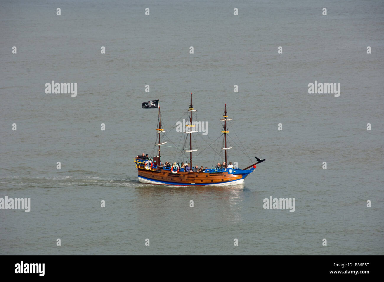 Pirate themed tourist passenger boat flying a black Jolly Roger flag ...