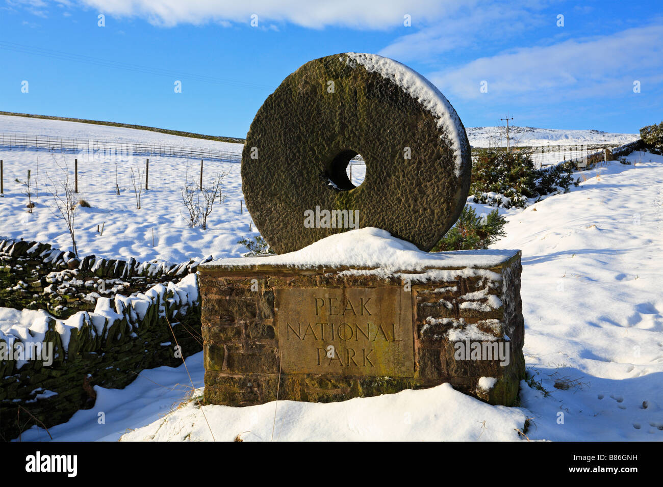 Snowy Peak District National Park millstone sign on Meltham Moor near ...