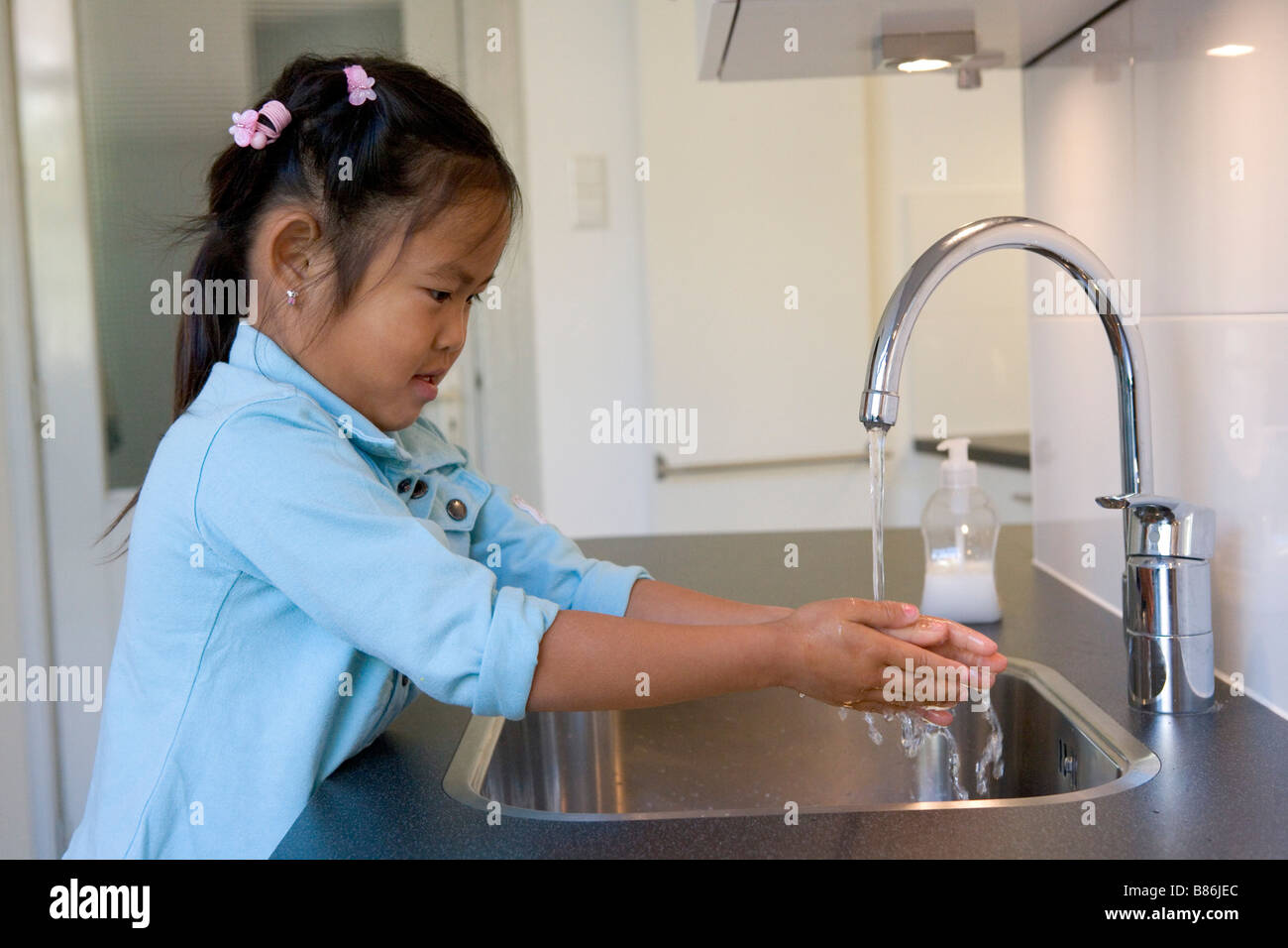 Little girl is washing her hands Stock Photo - Alamy