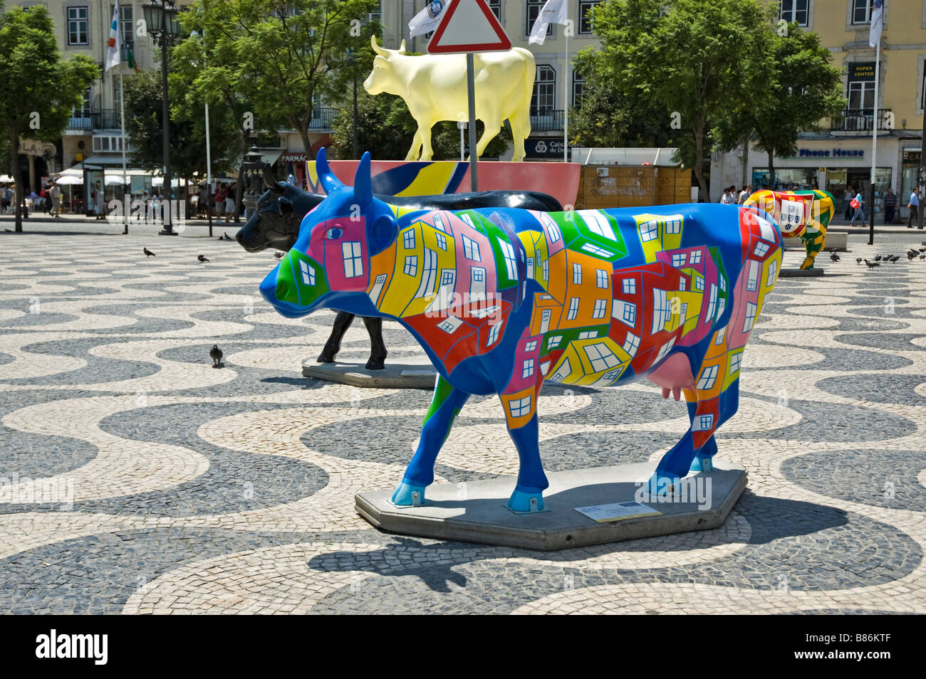 A herd of multicoloured full size fibreglass cows standing in Rossio ...