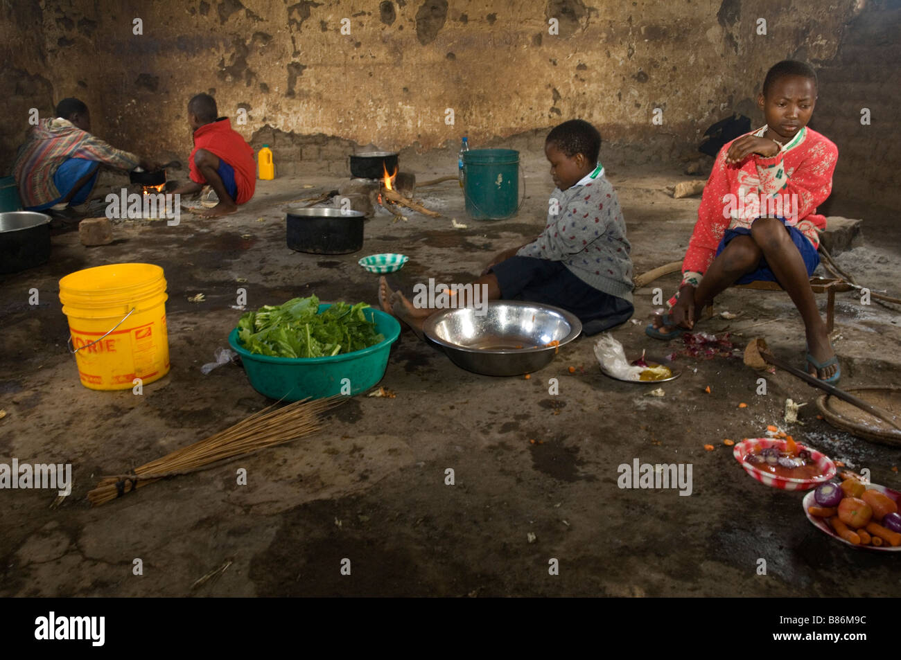 School children cooking lunch in the kitchen of a school in Mabogini ...