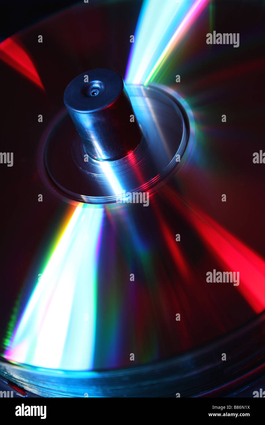 stack of CD's on a spindle lit with red and blue studio lighting Stock ...