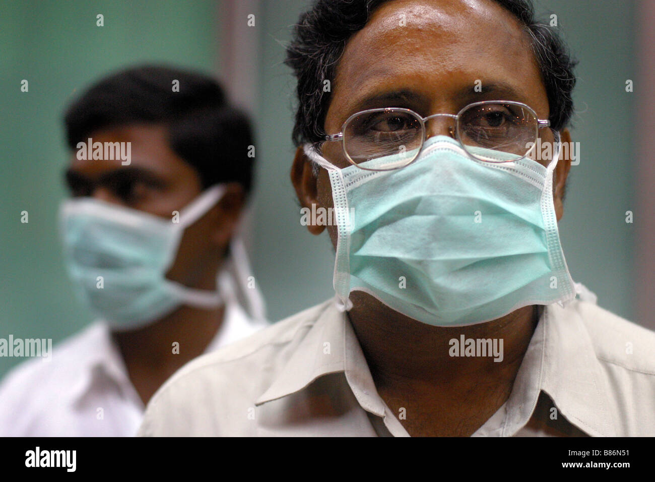 Two men wear protective masks to protect themselves against the SARS ...