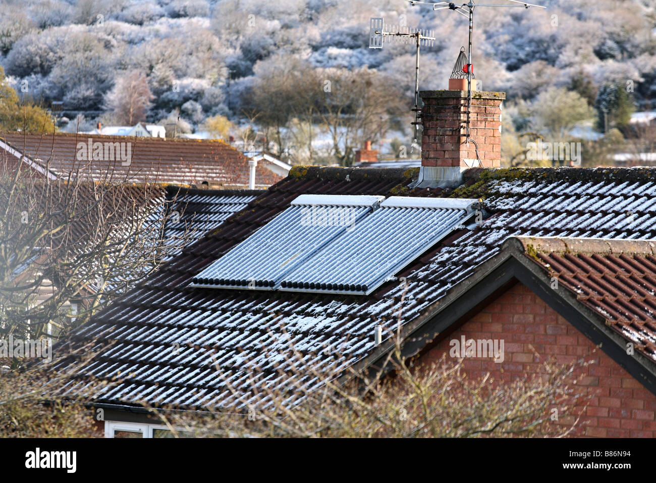 Light dusting of snow on the solar paneled roof Stock Photo - Alamy