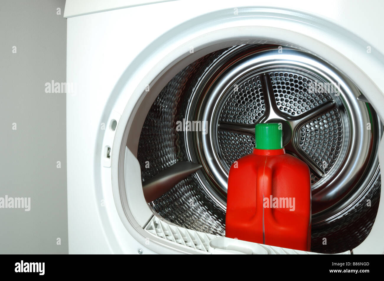 A container of detergent inside a laundry washing machine drying ...