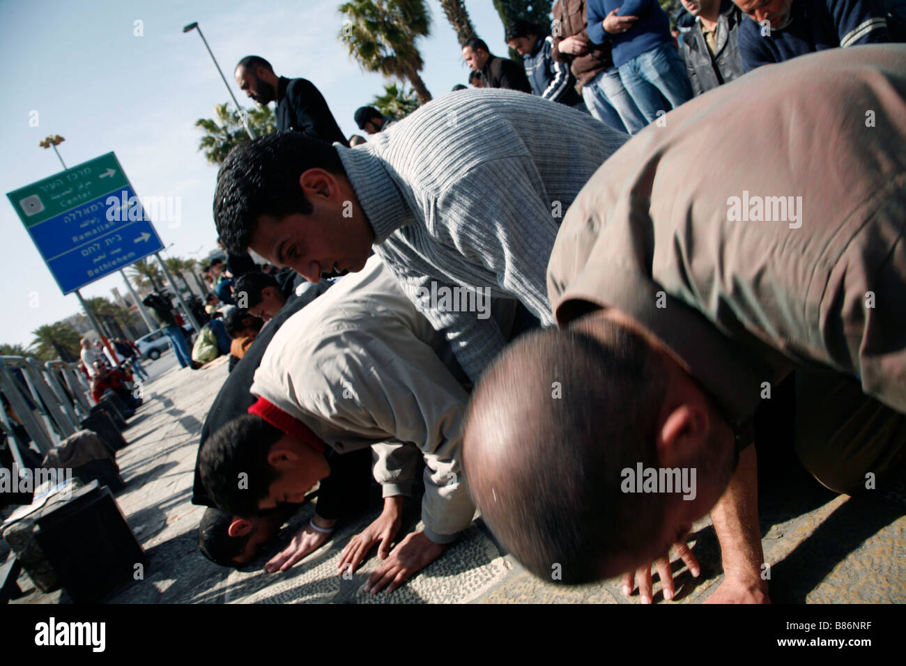 Palestinian Muslims praying outside the Damascus Gate of the Old City ...