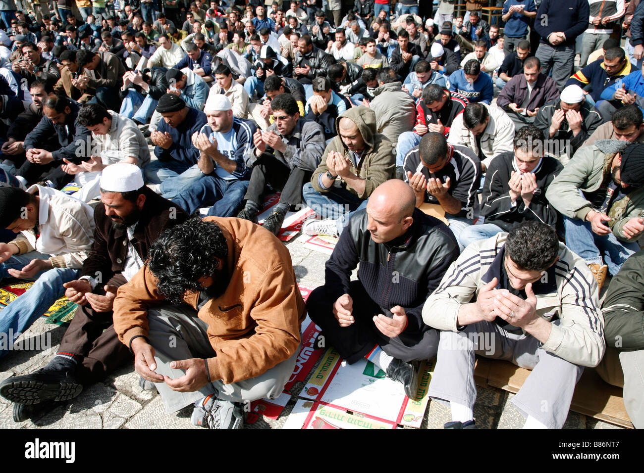 Palestinian Muslims praying outside the Damascus Gate of the Old City ...