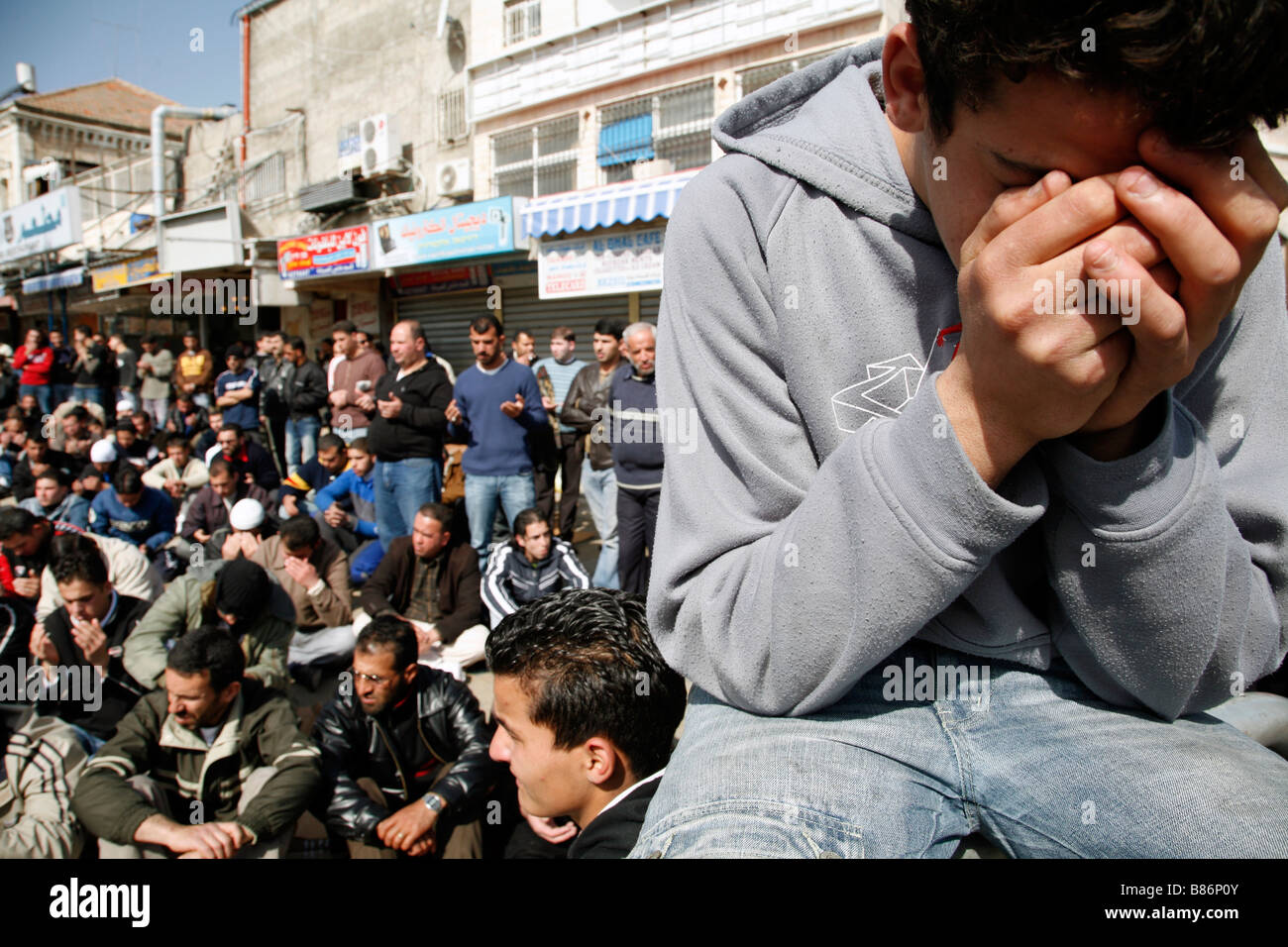 Palestinian Muslims praying outside the Damascus Gate of the Old City ...