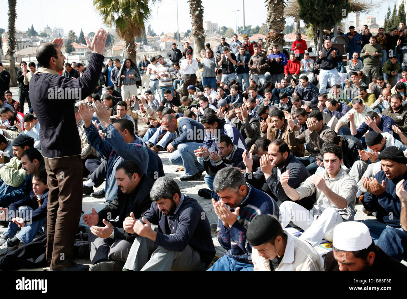Palestinian Muslims praying outside the Damascus Gate of the Old City ...