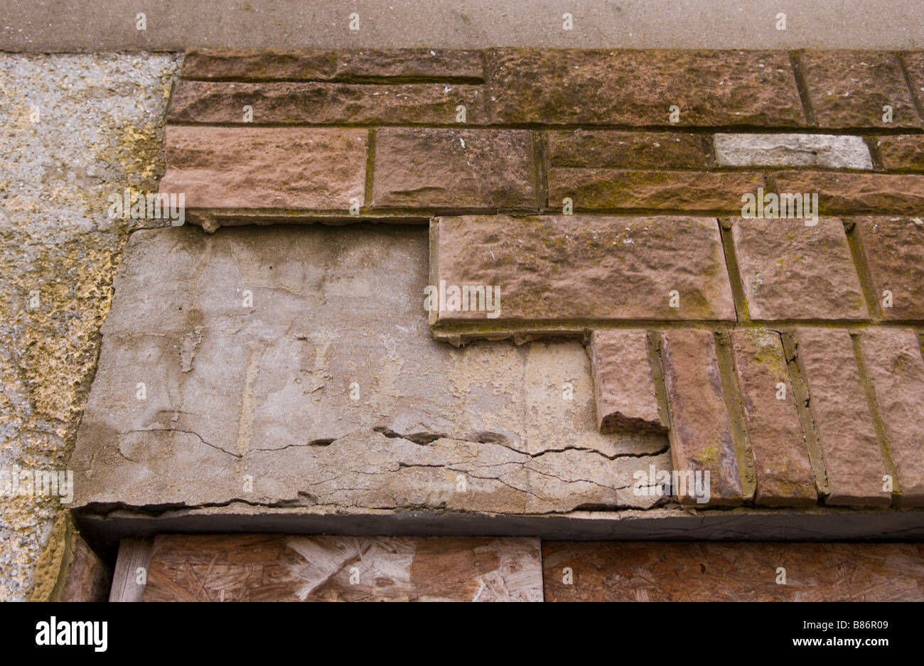 urban decay uk Stone cladding peeling off boarded up derelict house in ...
