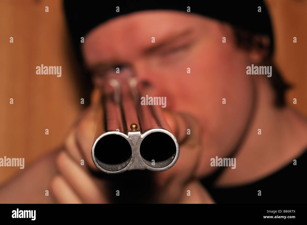 young man pointing shotgun with the end of the barrel in focus Stock Photo - Alamy