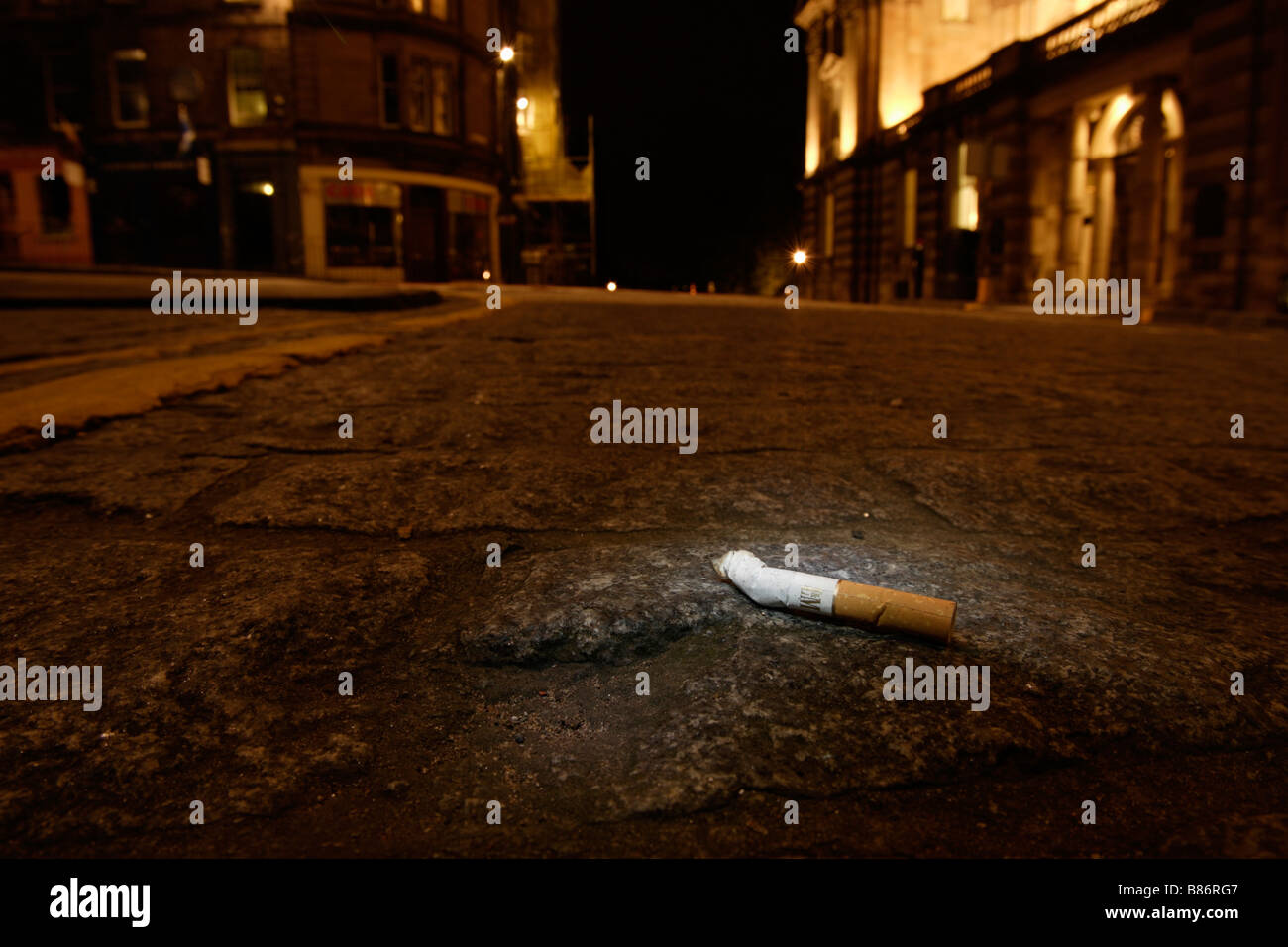 Cigarette litter at night on the streets of Edinburgh Stock Photo - Alamy