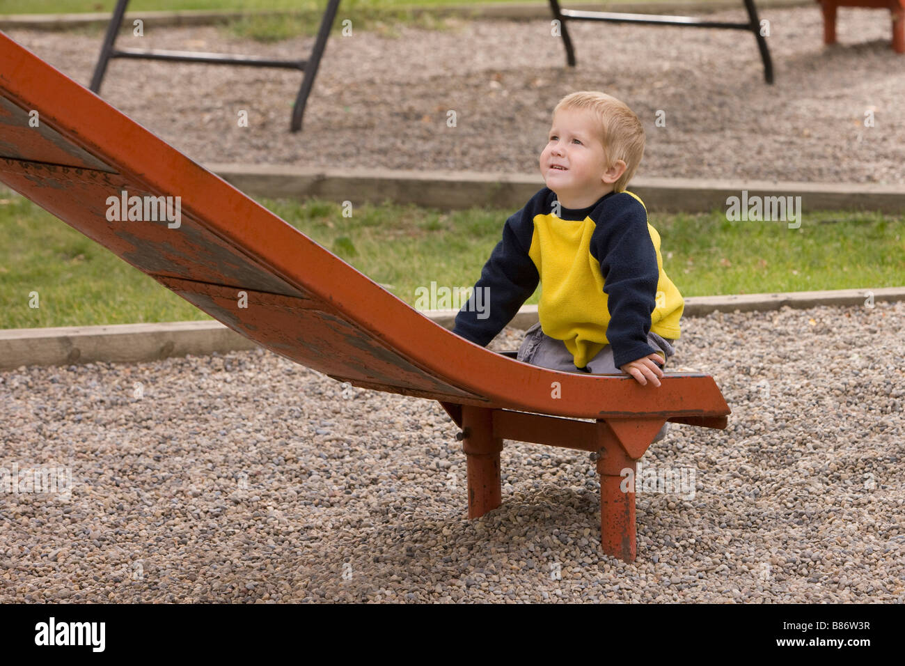 Boy playing at a park Stock Photo - Alamy