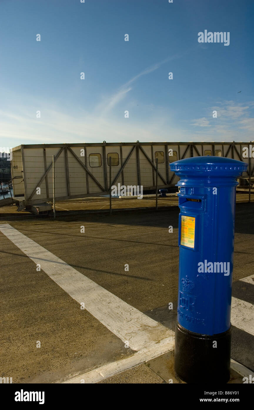 A Guernsey blue post box outside the St Peter Port harbour terminal ...