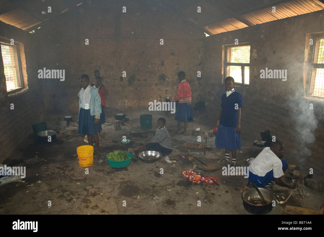School children cooking lunch in the kitchen of a school in Mabogini ...