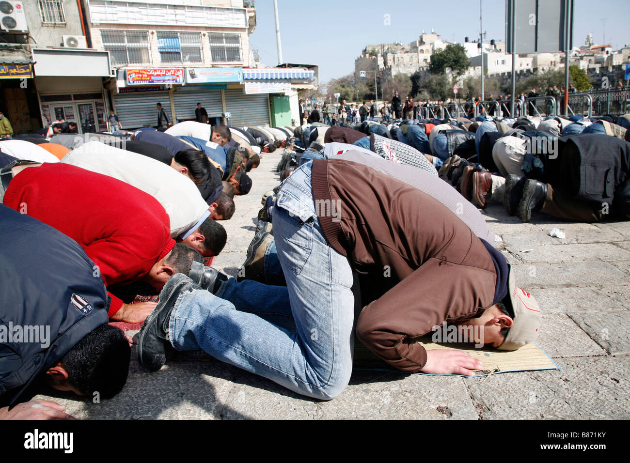Palestinian Muslims praying outside the Damascus Gate of the Old City ...