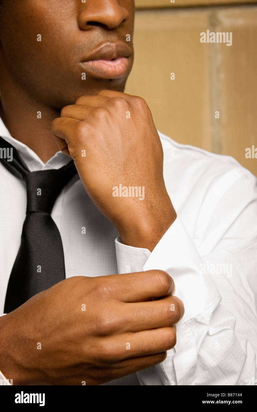 Man buttoning cuffs Stock Photo - Alamy