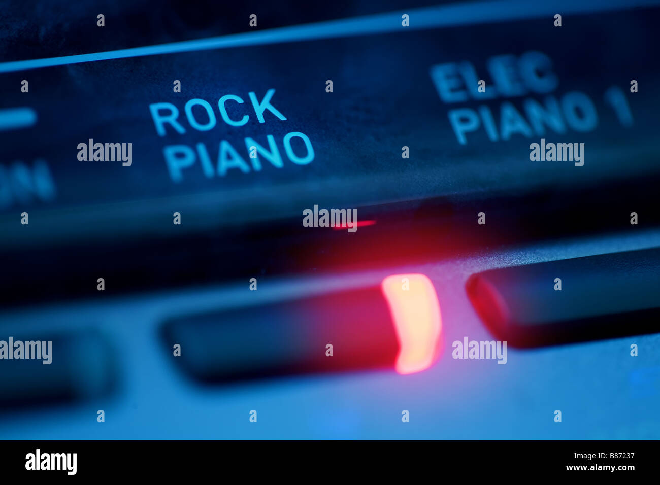 closeup of a digital piano with the "rock piano" sound style button ...