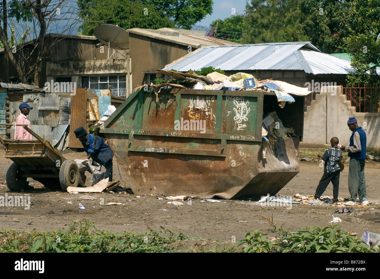 People seaching through the litter at a garbage collection point in ...