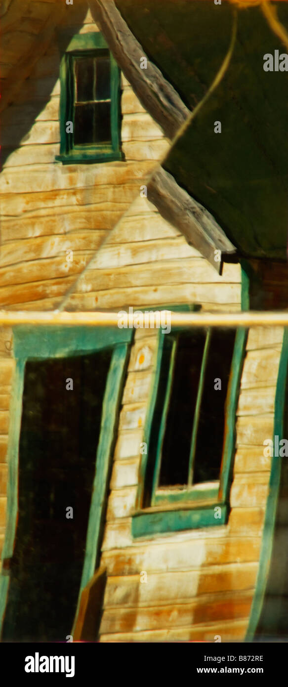 Creepy distorted reflection of an old house in the shattered window of ...