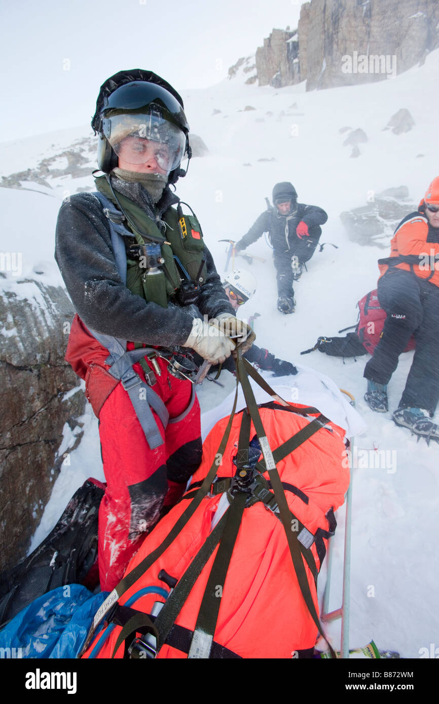 A Navy Sea King helicopter crew and mountain rescue team members treat ...