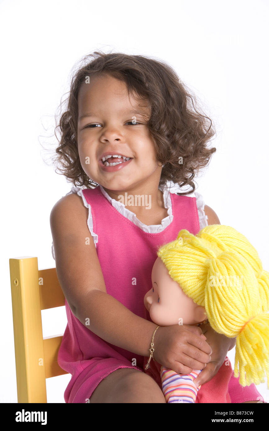Portrait of a happy little girl with her doll Stock Photo - Alamy