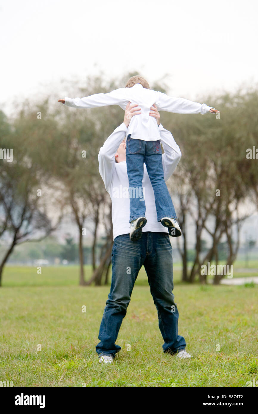 Father lifting his son in the air Stock Photo - Alamy