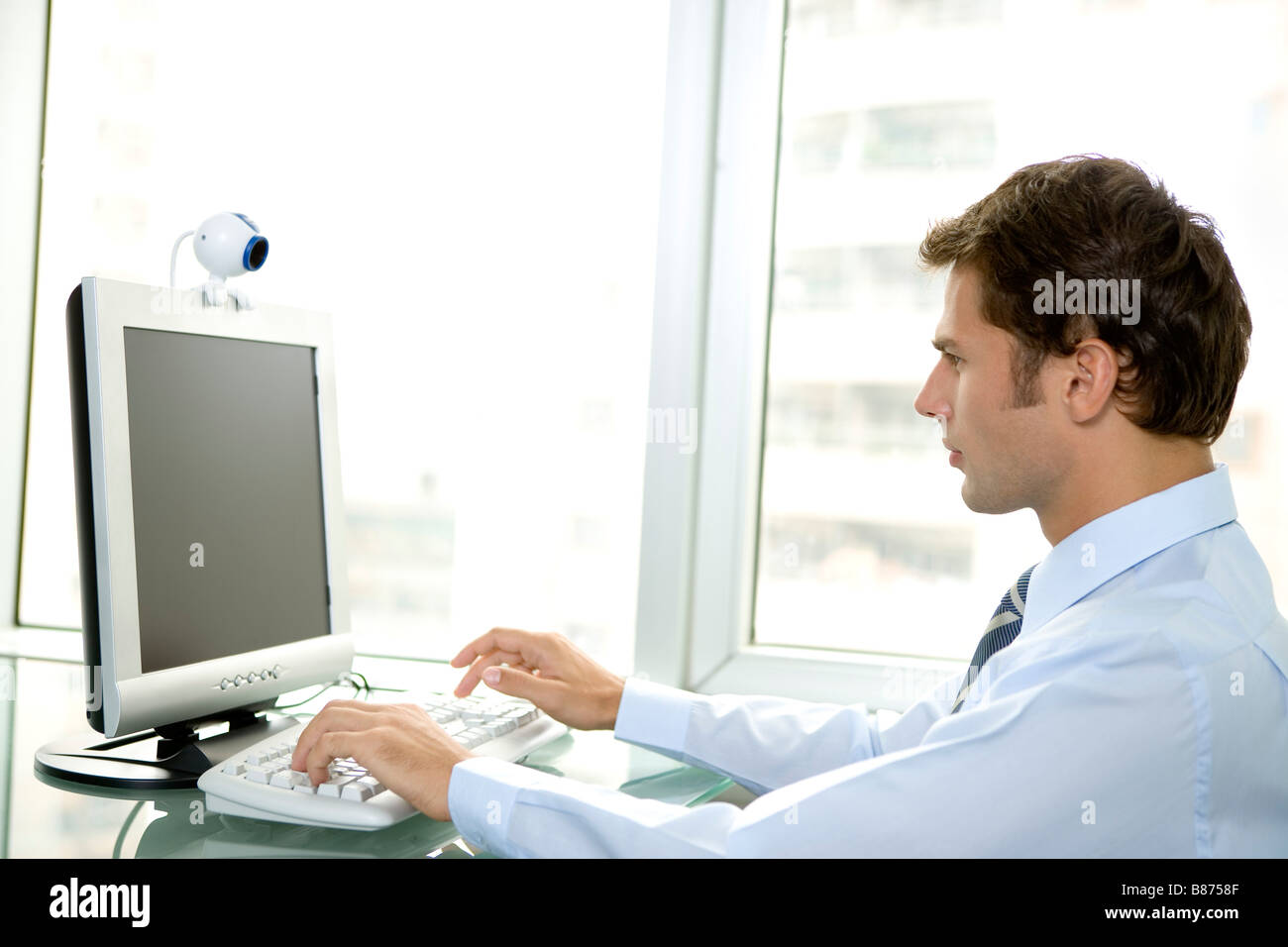 Businessman typing keyboard by table side view Stock Photo - Alamy
