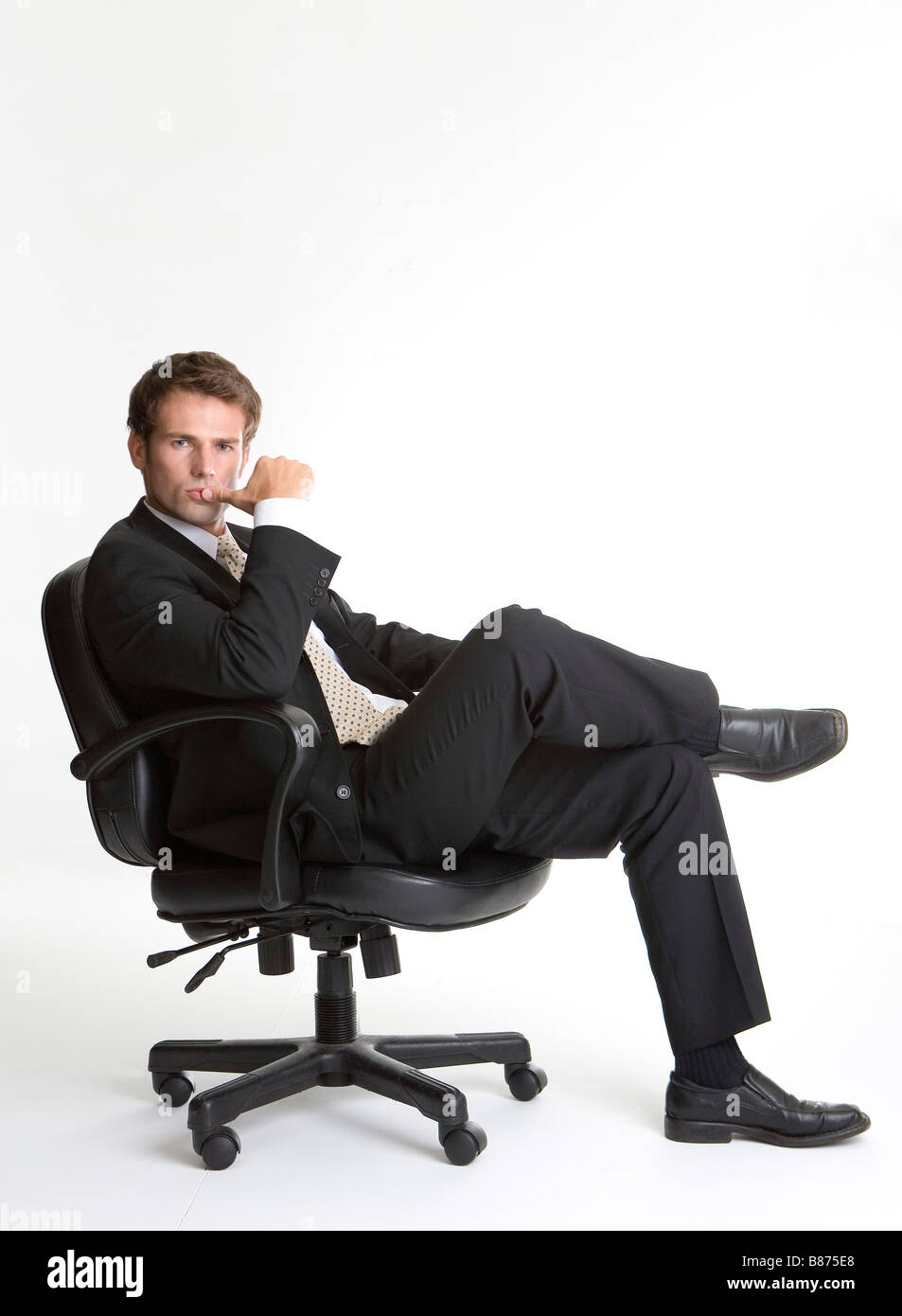 Businessman sitting on chair looking at camera Stock Photo - Alamy