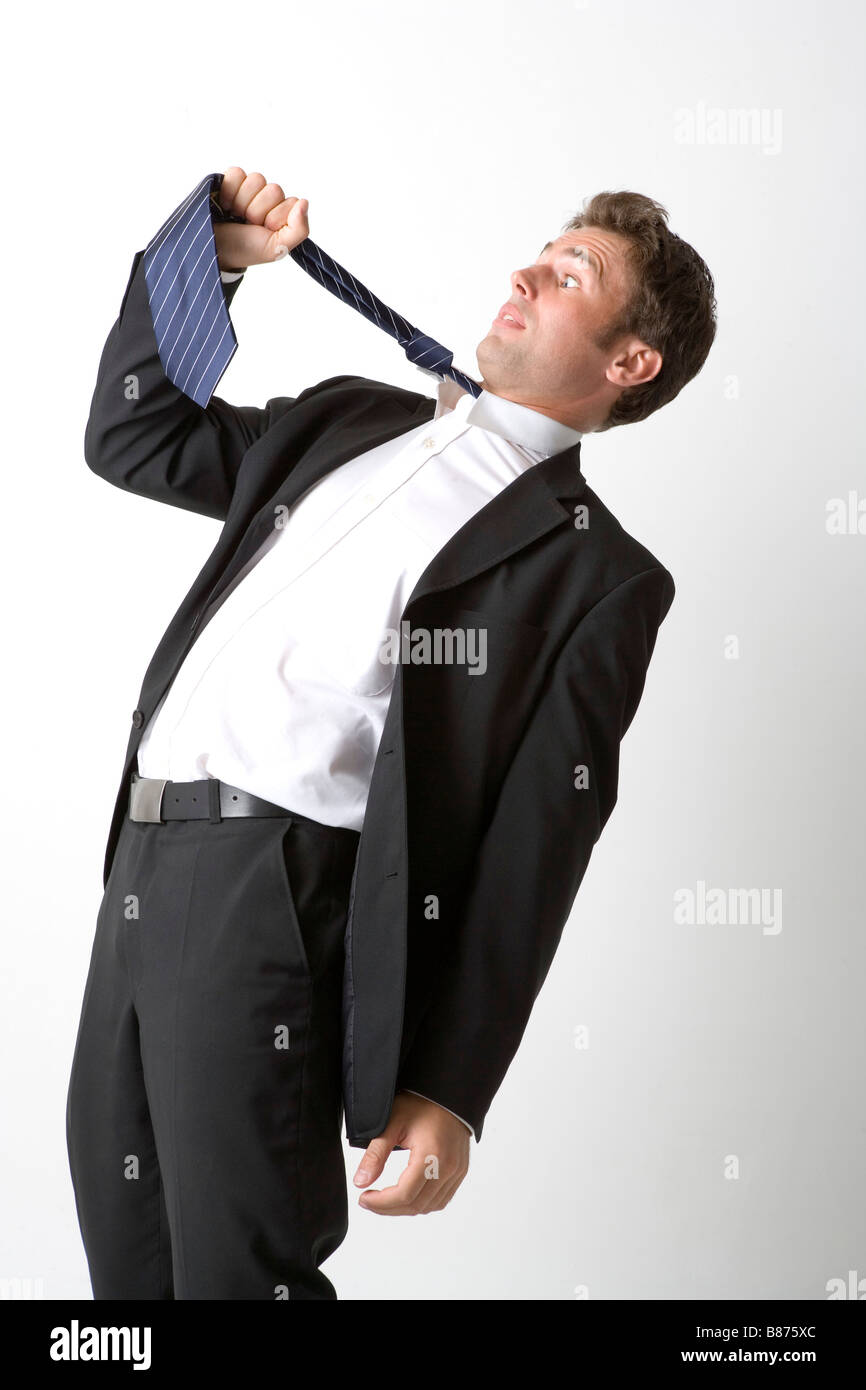 Businessman pulling his tie up side view Stock Photo - Alamy