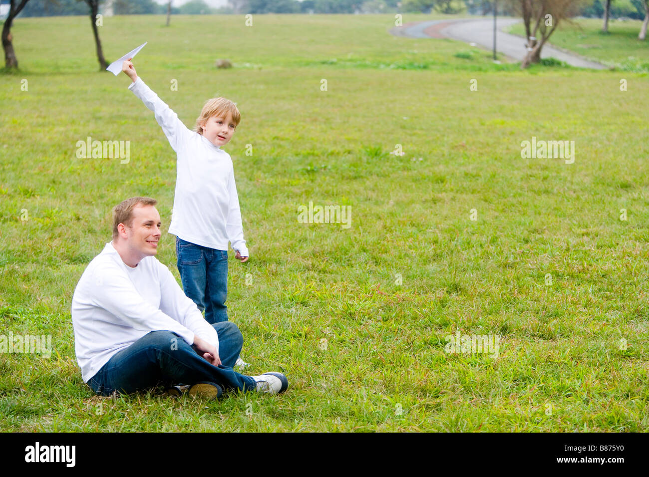 Boy playing paper plane side view Stock Photo - Alamy