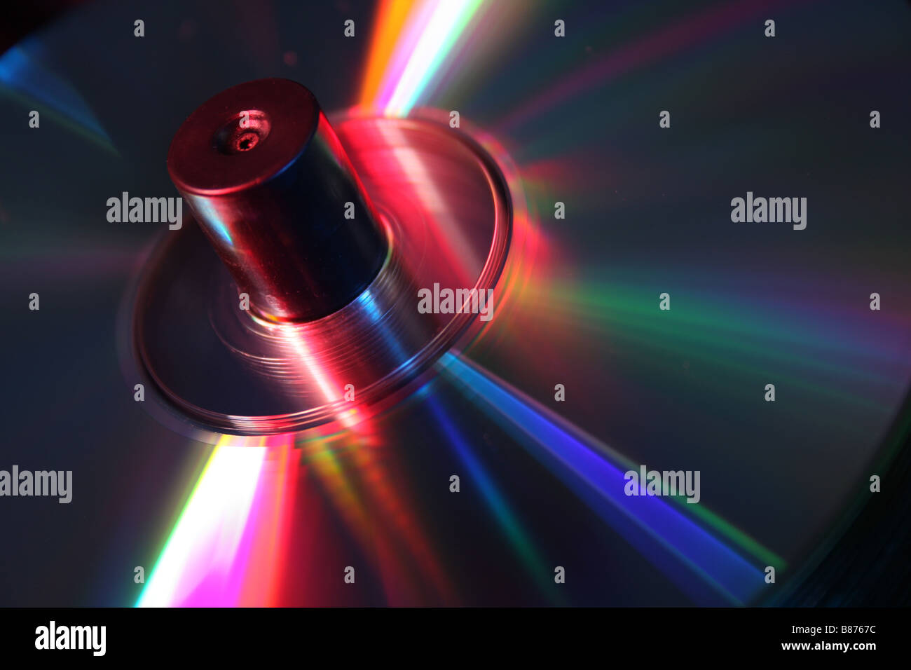 stack of CD's on a spindle lit with red and blue studio lighting Stock ...