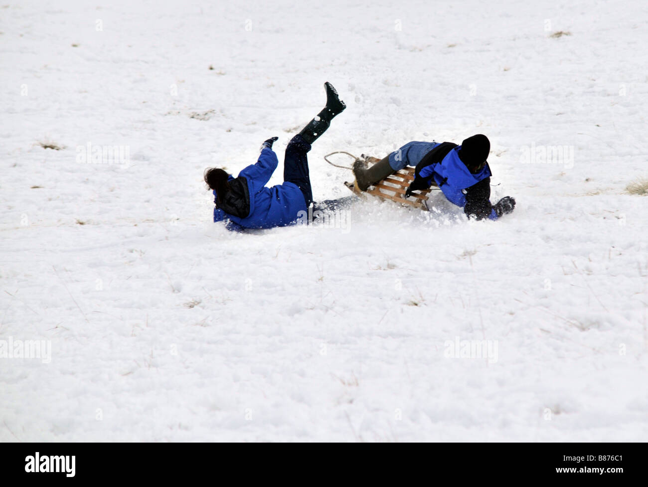 couple dressed in blue falling of a sledge in Derbyshire after heavy ...