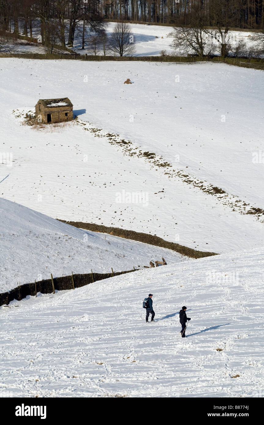Hiking Snow scene with Walkers in the Derbyshire countryside after ...