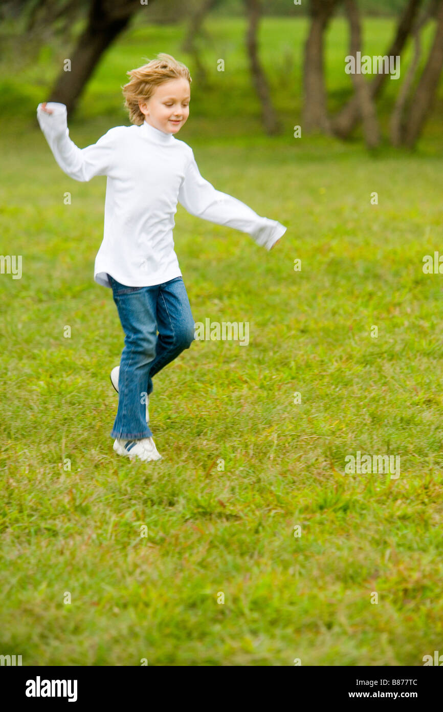 Boy running with his hair blowing in the wind Stock Photo - Alamy