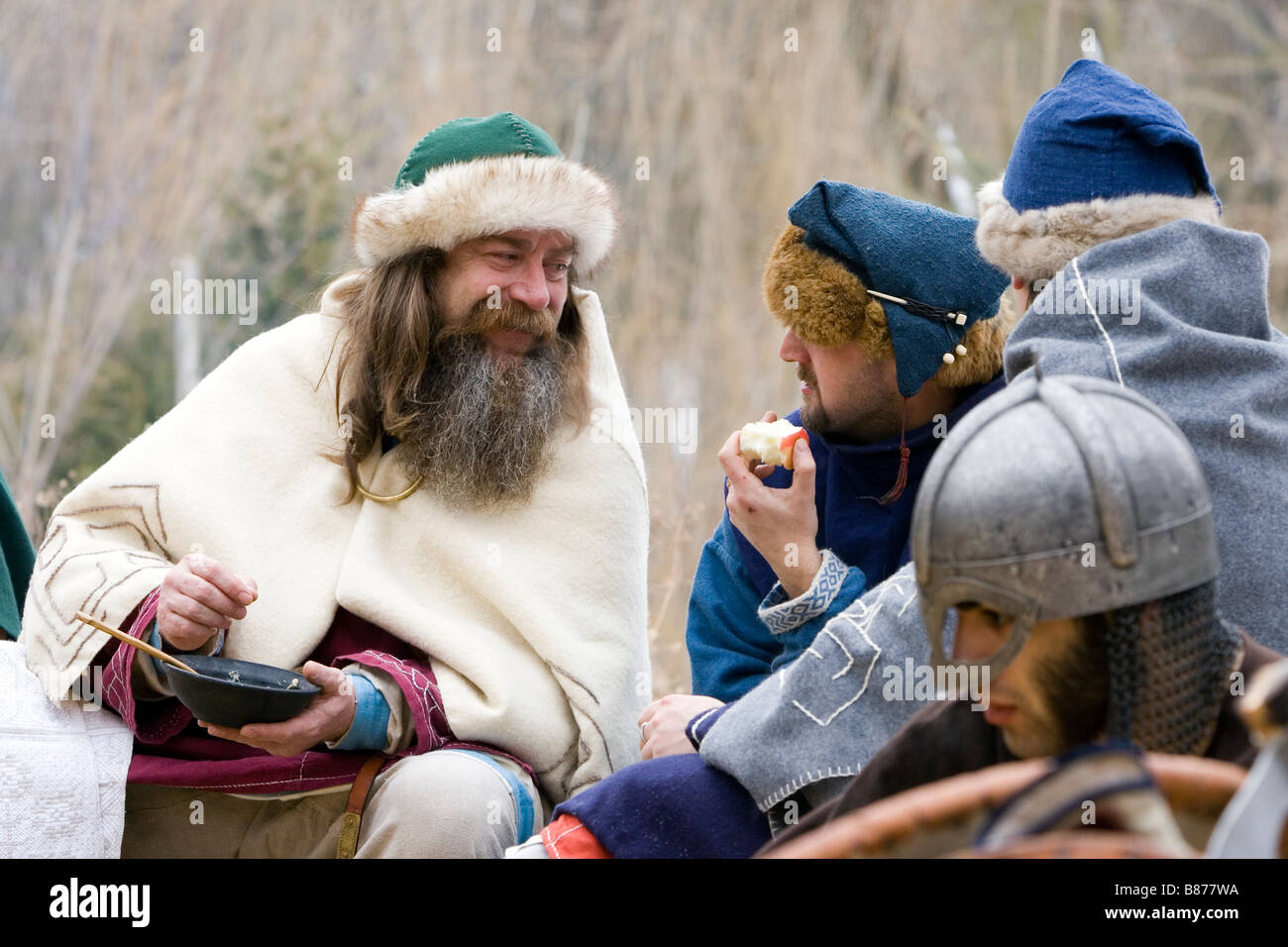 people dressed like a viking sitting and eating Stock Photo - Alamy